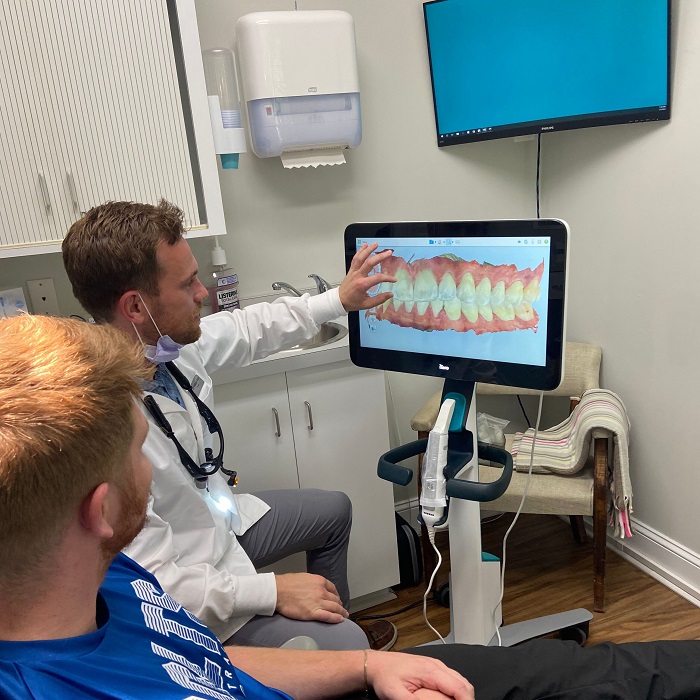 Wilmington dentist Dr. William Watt explaining teeth straightening ...